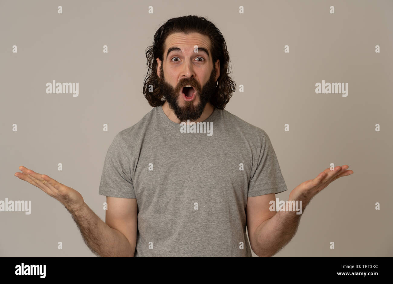 Portrait of funny attractive hipster man with happy and surprised face ...