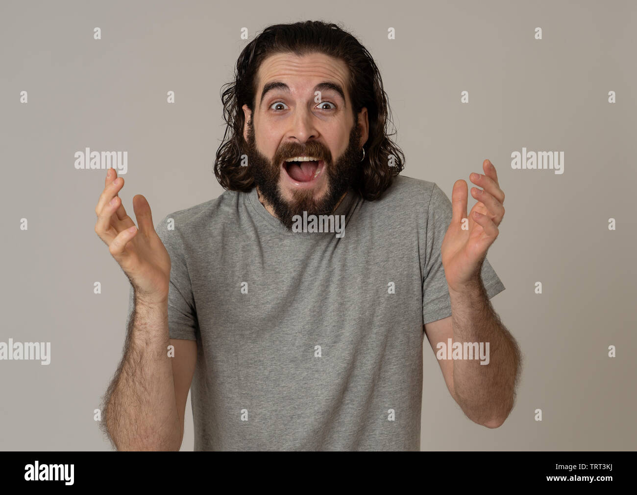 Portrait of funny attractive hipster man with happy and surprised face ...