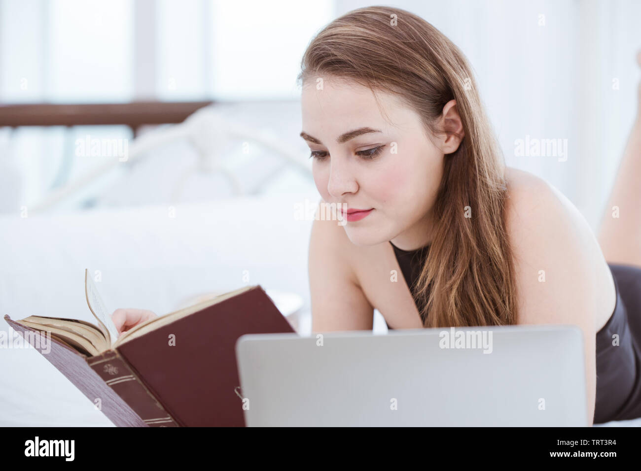 Beautiful Girl Teen Reading a Book Lay on Bed Stock Photo - Alamy
