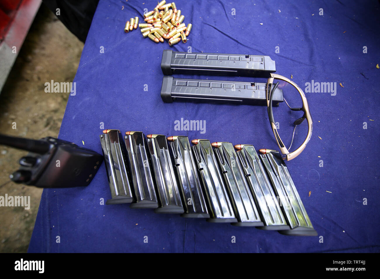 Details with gun clips, 9mm ammunition and protective glasses on a ...
