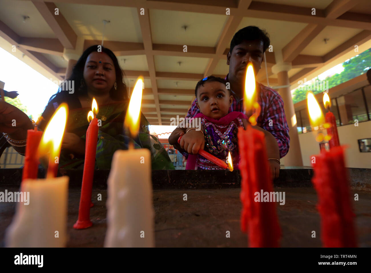 Devotees light candles at Dhakeshwari Temple during Durga Puja. Dhaka ...