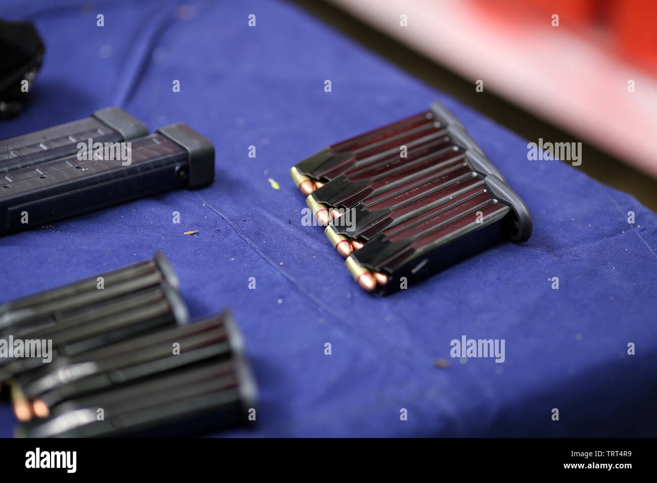 Details with gun clips and 9mm ammunition on a table on a shooting ...