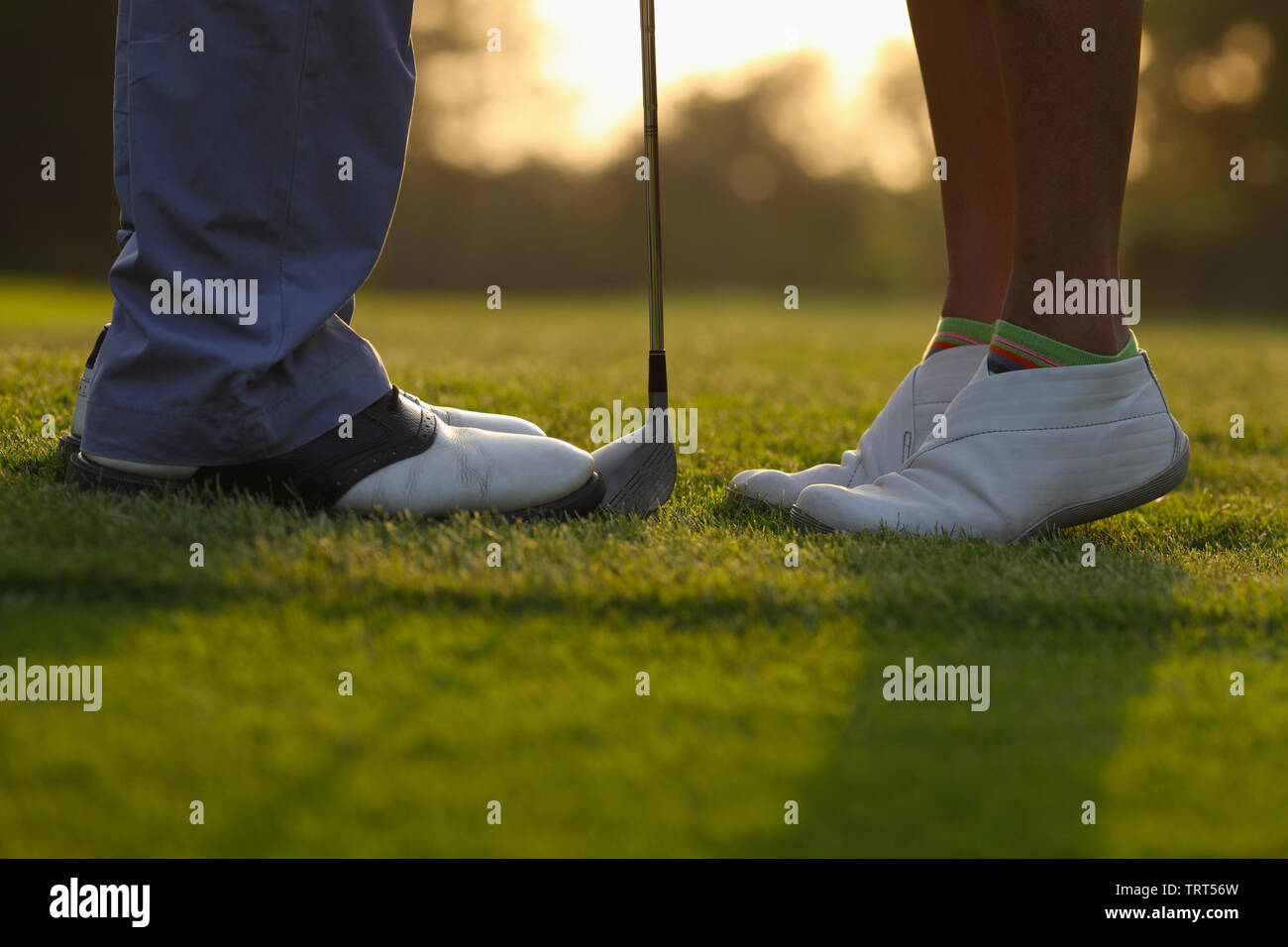 Low section view of two golfers standing in a golf course Stock Photo ...