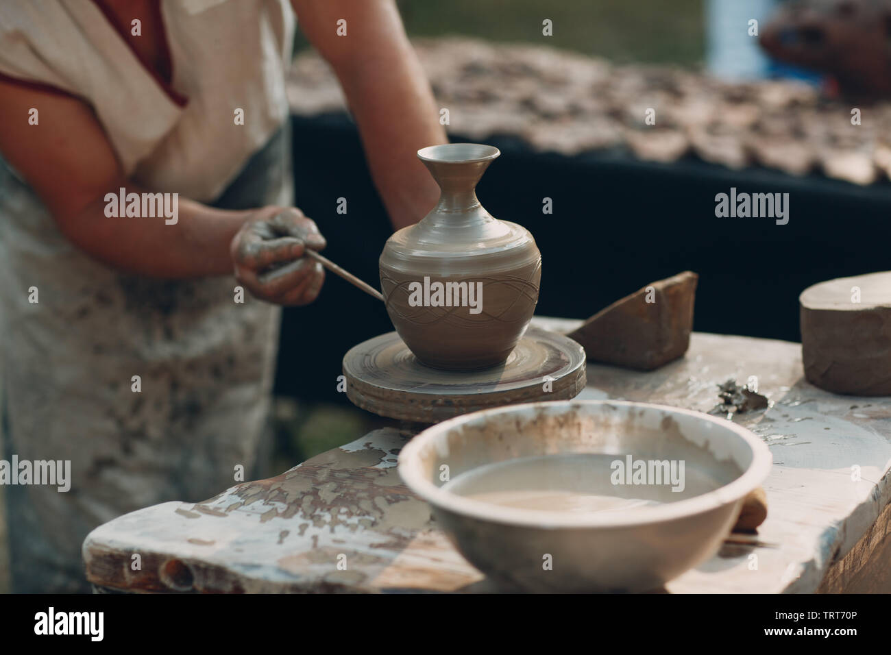 Potter makes clay pot jar on potter's wheel Stock Photo - Alamy