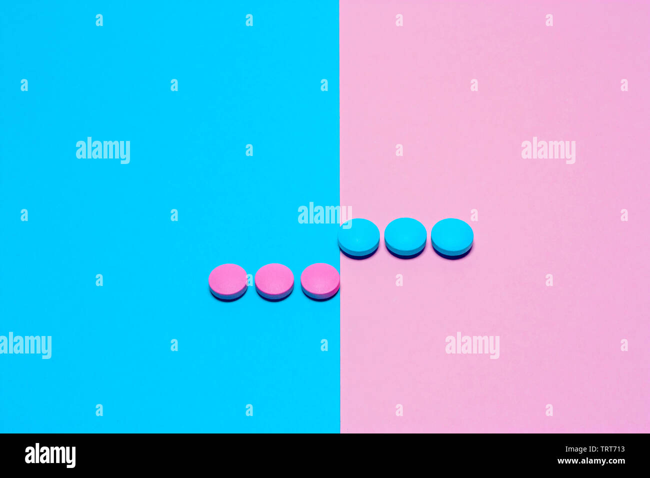 blue and pink tablets on a paper background of blue and pink ...