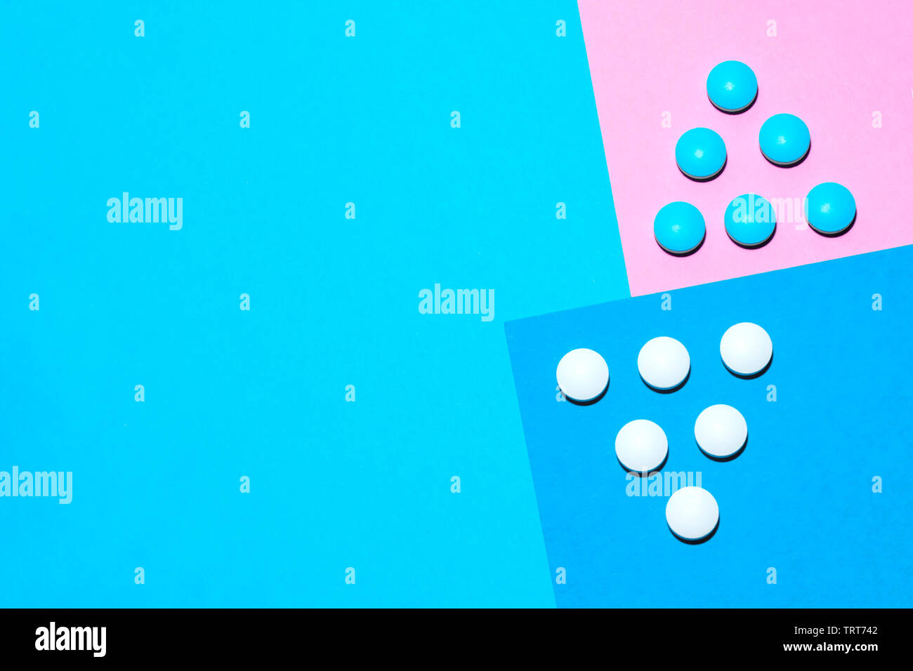 blue and white tablets laid out in the form of a triangle or an arrow ...