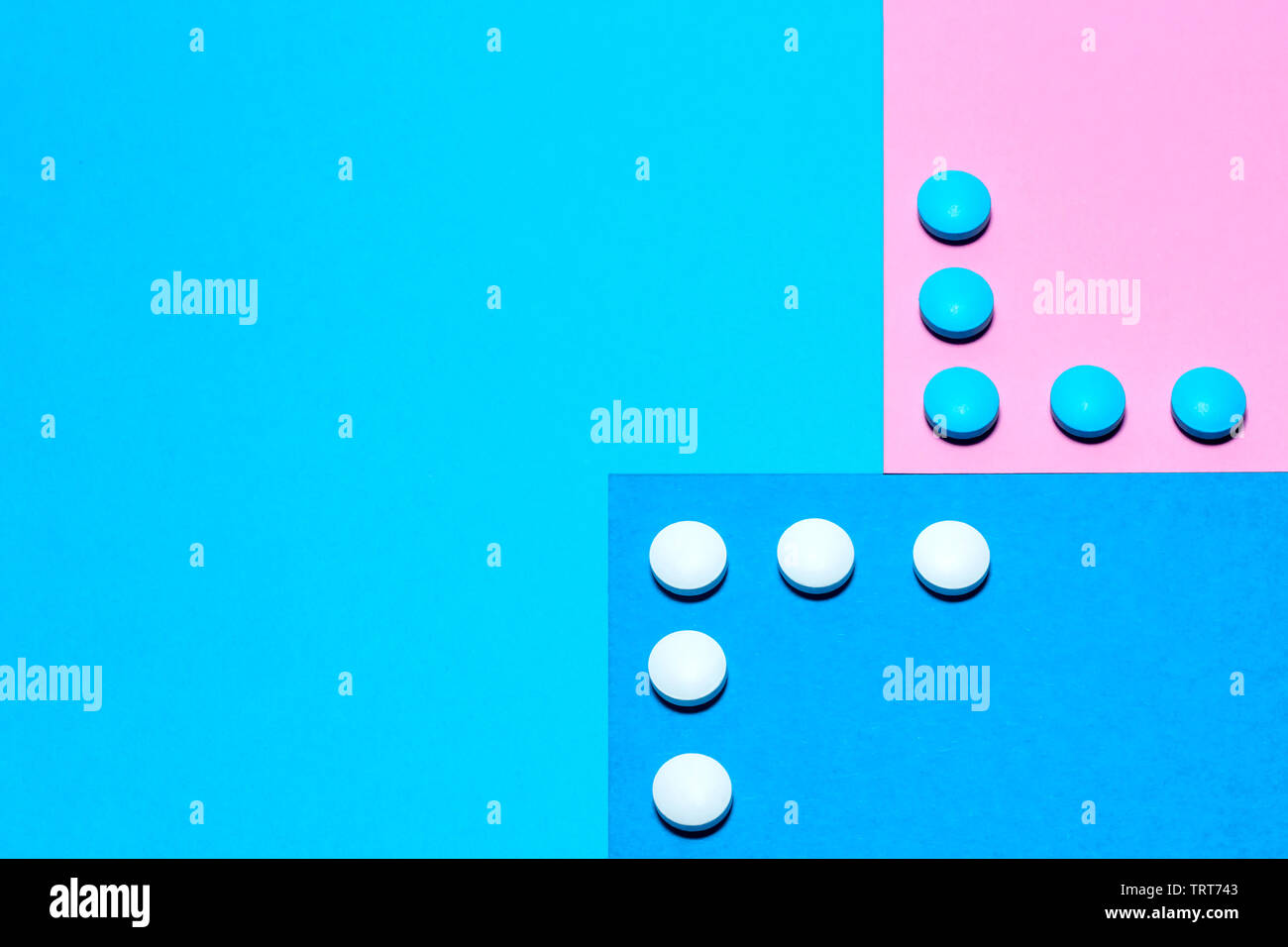 blue and white tablets laid out in the form of a triangle or an arrow ...