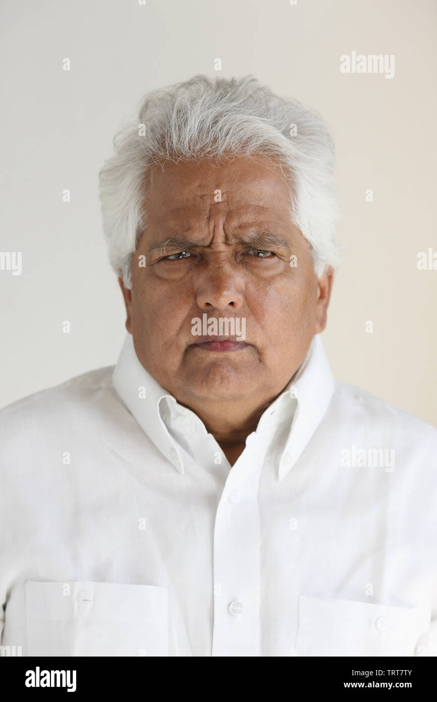 Close up of an Indian man looking grumpy Stock Photo - Alamy