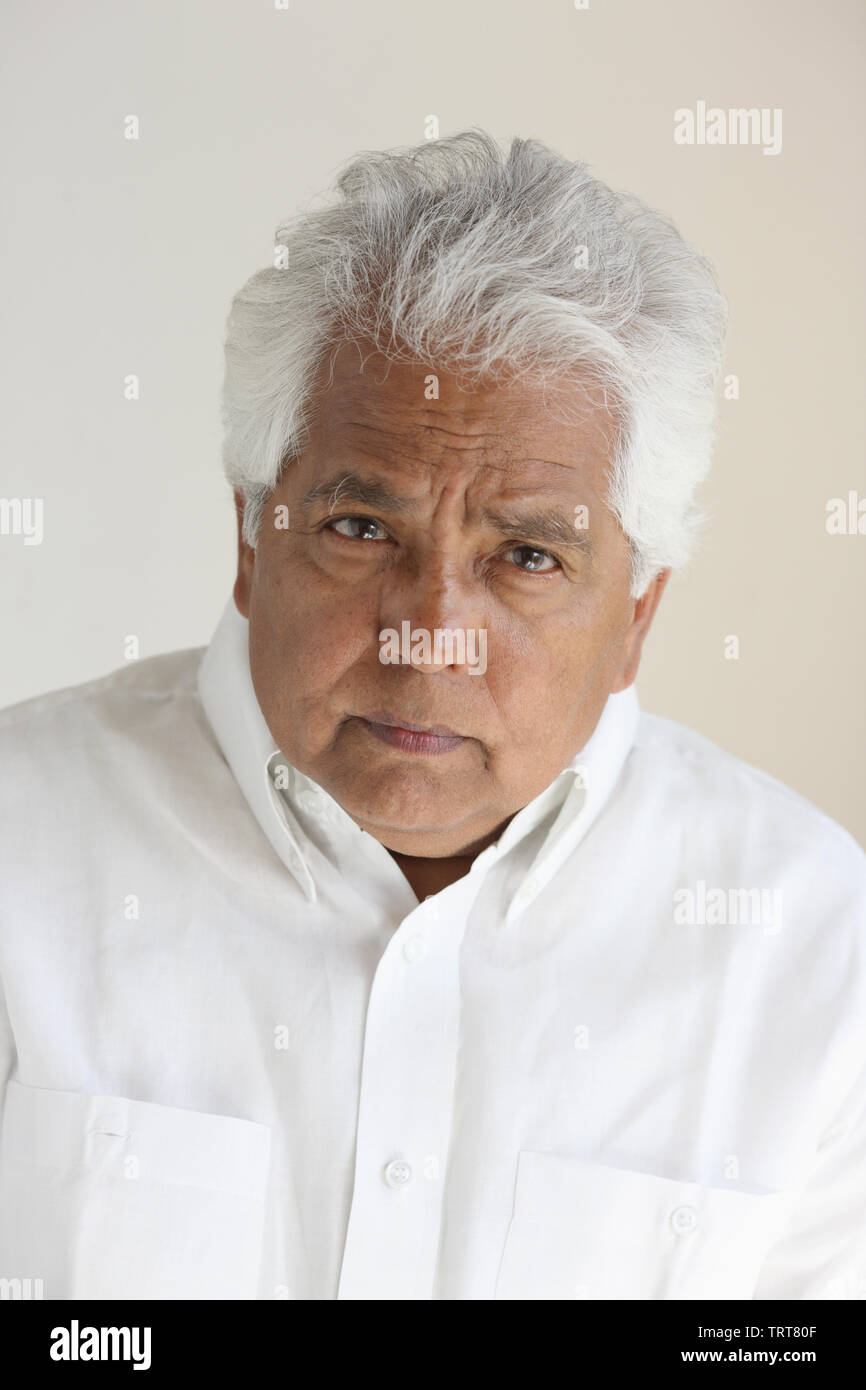 Close up of an Indian man looking grumpy Stock Photo - Alamy