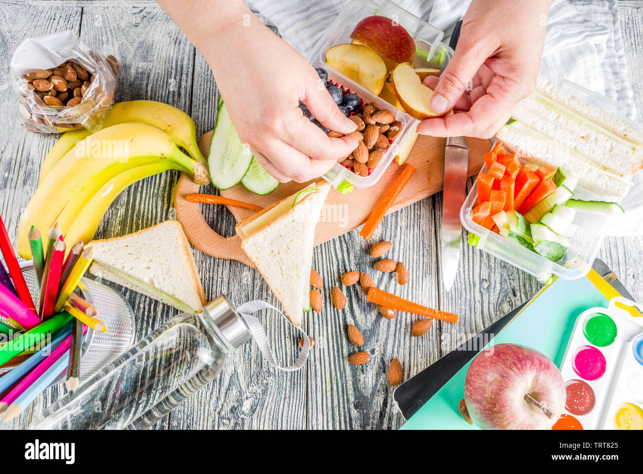 Mother cooking school lunch box set, Preparing healthy snacks - cheese ...