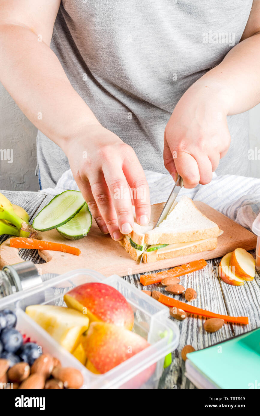 Mother cooking school lunch box set, Preparing healthy snacks - cheese ...