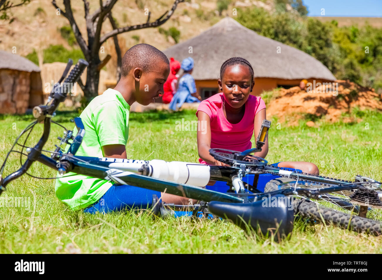 Harrismith, South Africa - October 18 2012: African Children fixing a ...