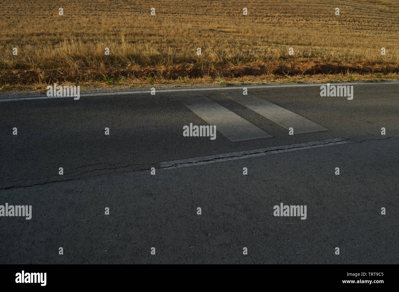 View of landscape,stony pavement and road with double yellow lines in ...