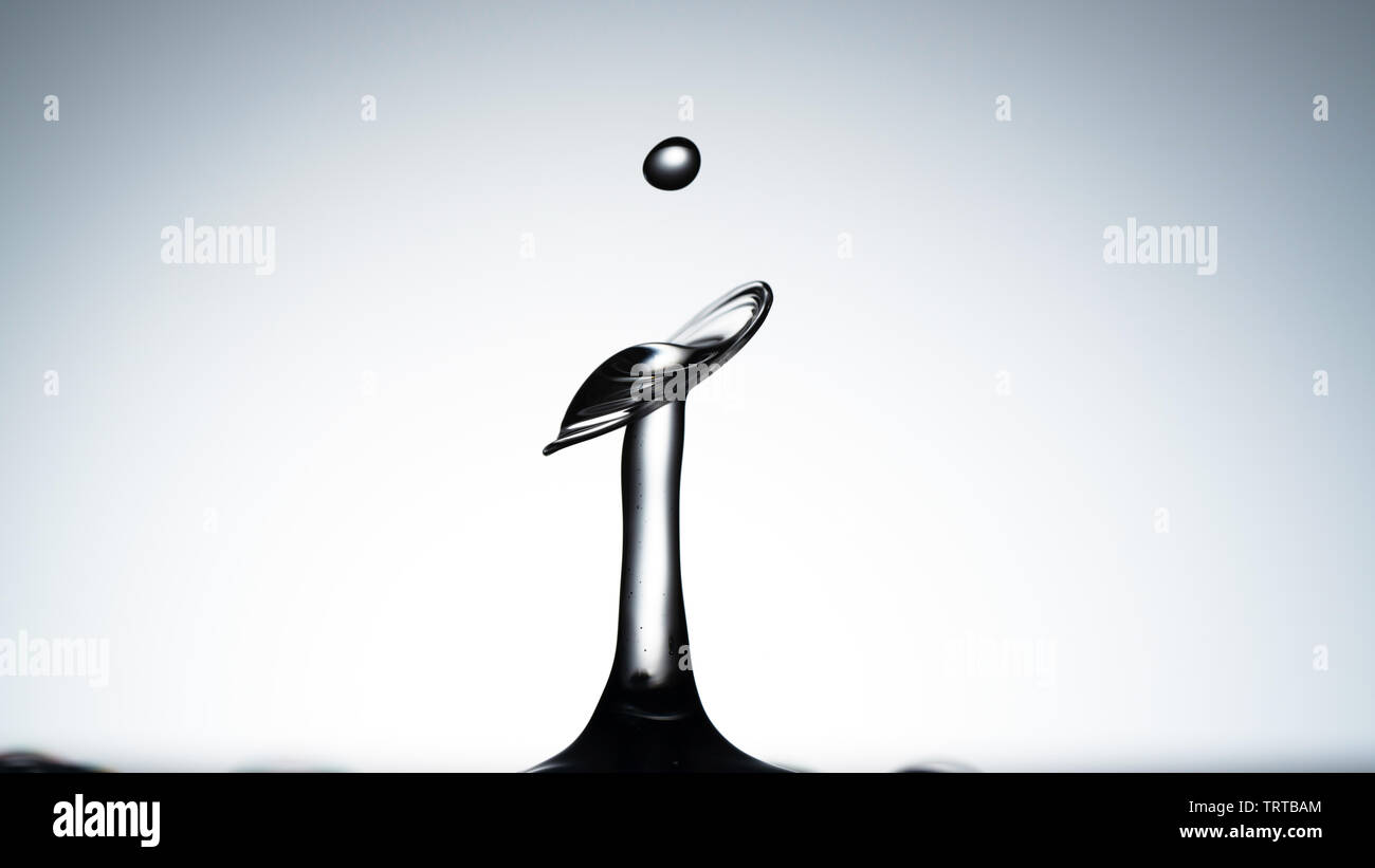 Close-up of a water drop falling on water surface Stock Photo - Alamy