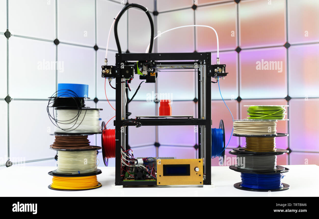 3d printer and plastic filament on color background Stock Photo - Alamy
