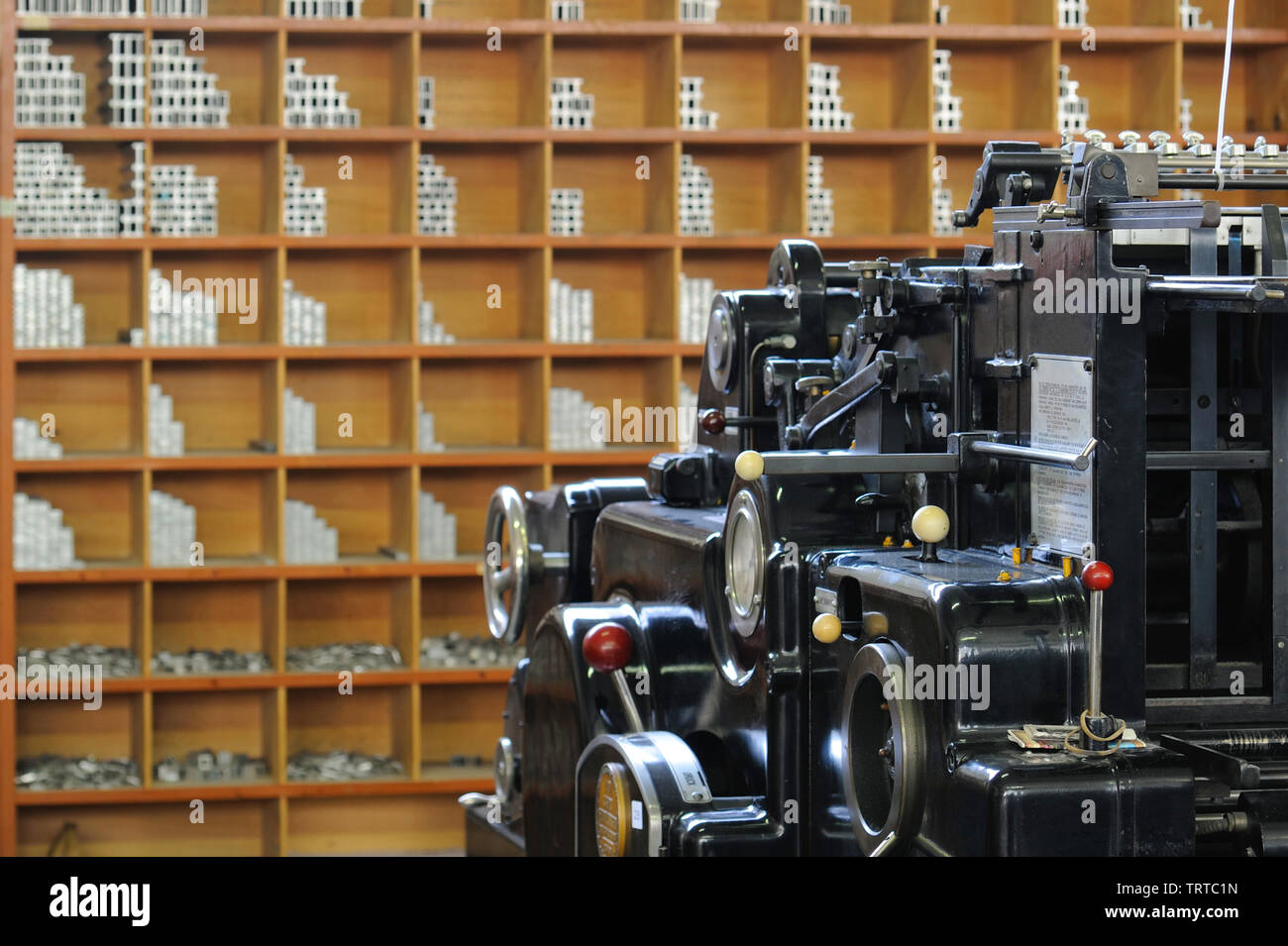 detail of an old printing press and in the background old filling lead ...