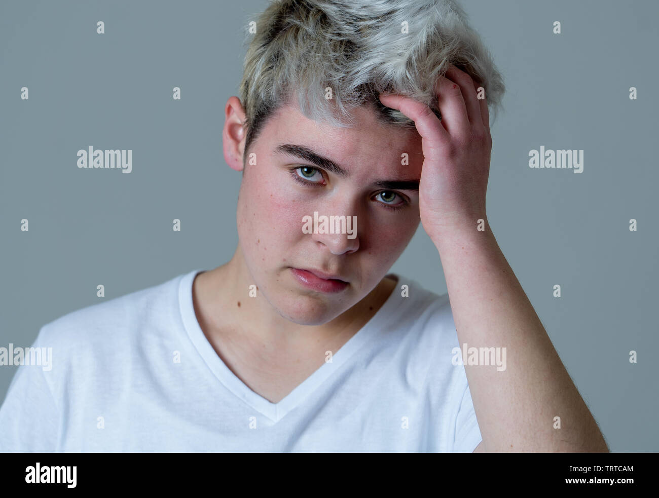 Young sad trans teenager boy suffering from depression feeling sad and ...