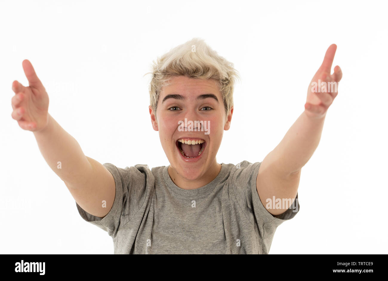Portrait of good looking young teenager man welcoming with open arms ...