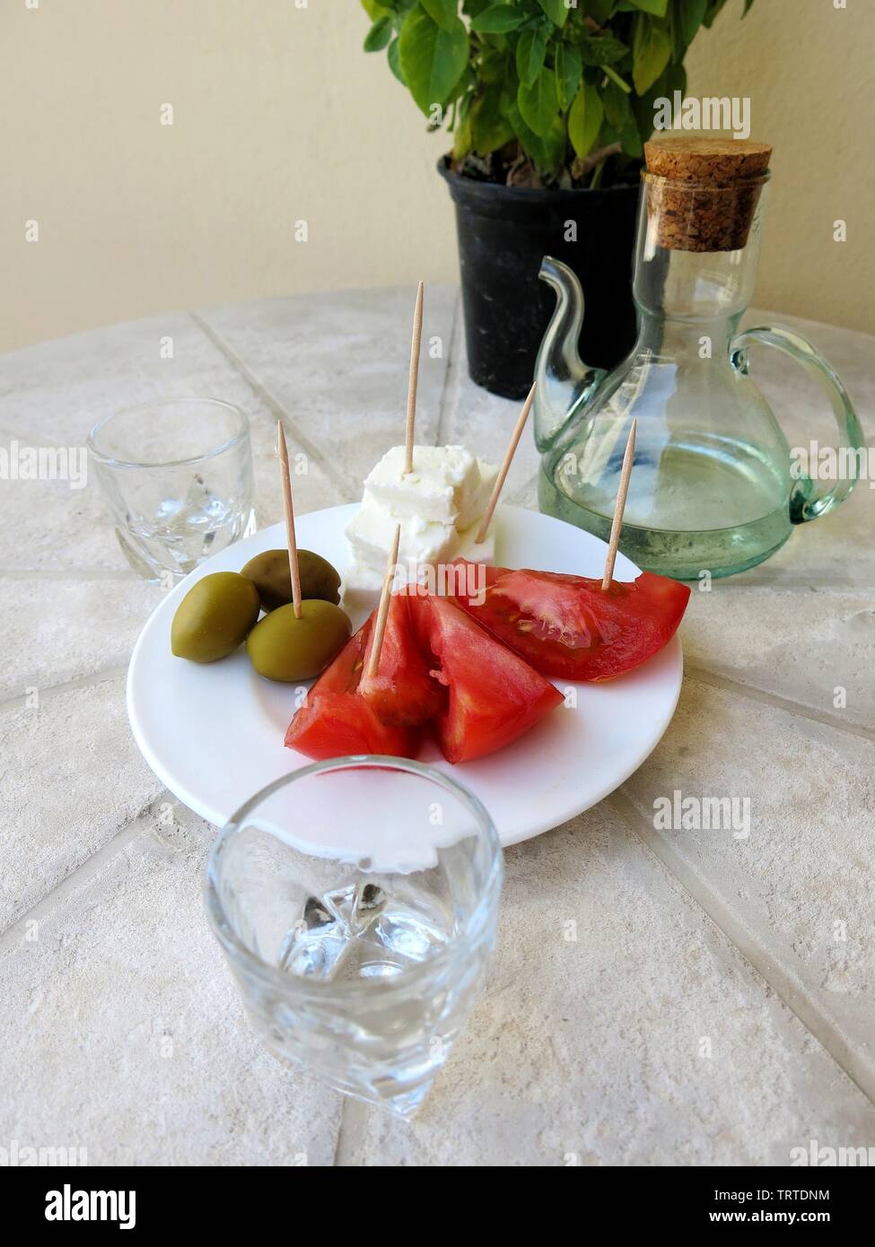 Raki served with a snack or meze as it is called in Greece Stock Photo ...