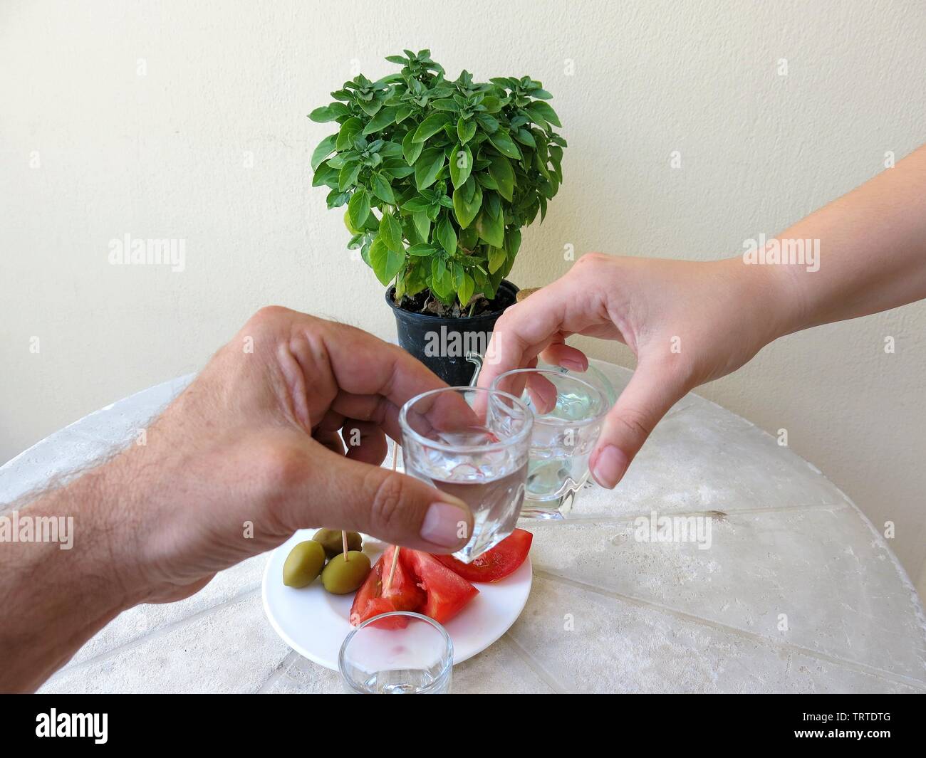 Raki served with a snack or meze as it is called in Greece Stock Photo ...