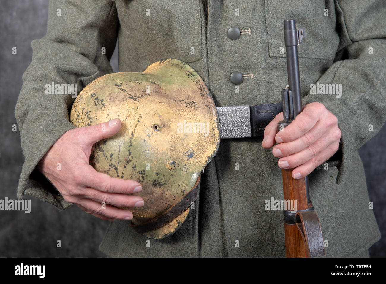 a close up of rifle and helmet on the German soldier, second world war ...