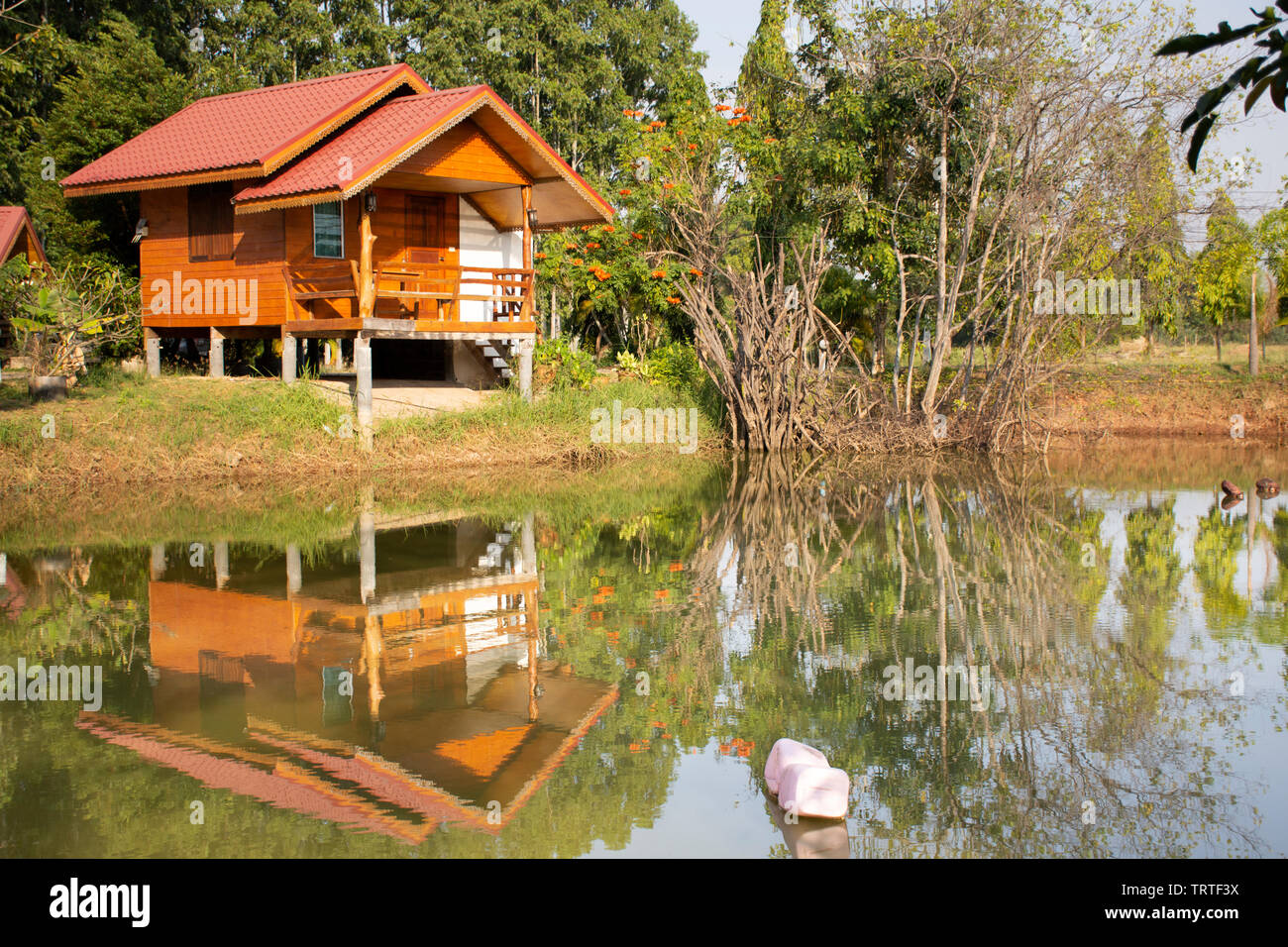 Wooden hut in garden with pond of resort and homestay for thai people ...