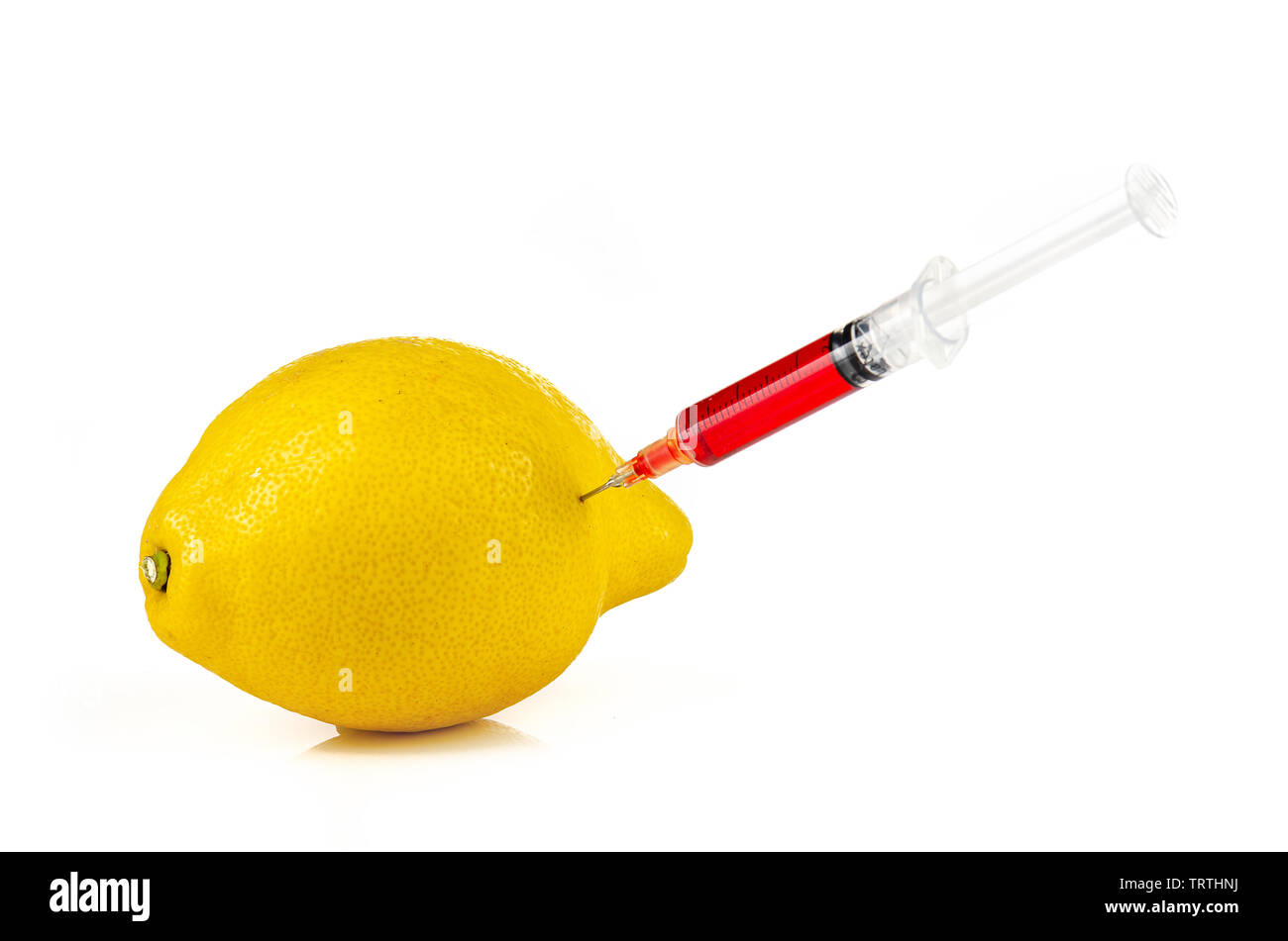 Lemon with injection of a red liquid Stock Photo - Alamy