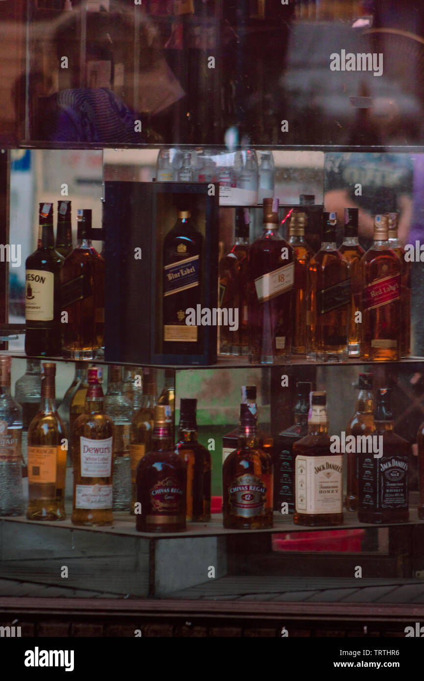 Different liquors showcased in front of a liquor shop Stock Photo - Alamy