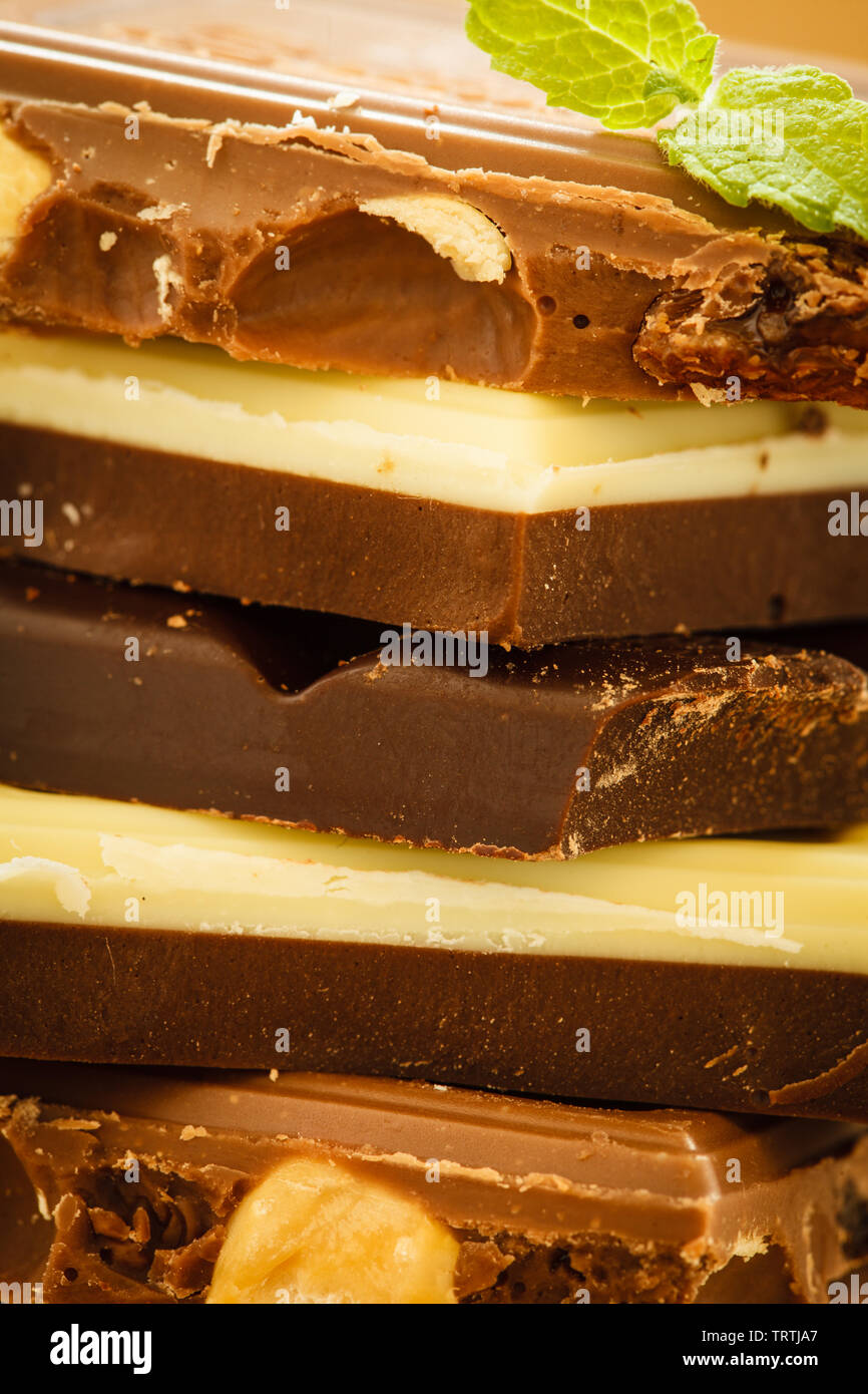 Closeup stack of different sorts chocolate pieces. Variety of ...