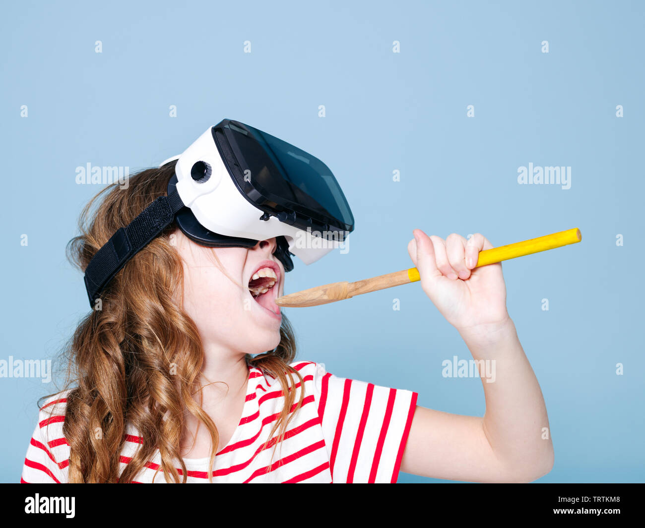 cool and smiling positive girl wearing virtual reality glasses goggles ...