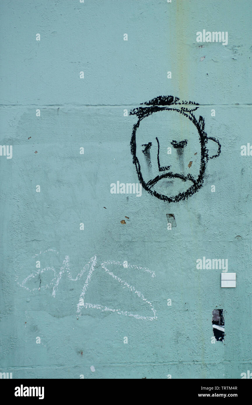 Sad face graffiti on wall hi-res stock photography and images - Alamy