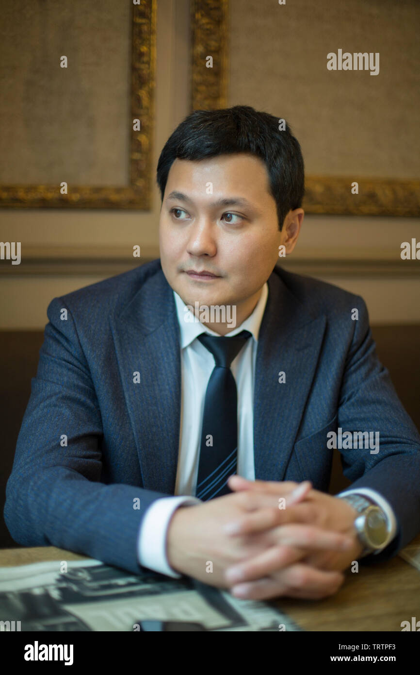 Asian businessman in black suit Stock Photo - Alamy