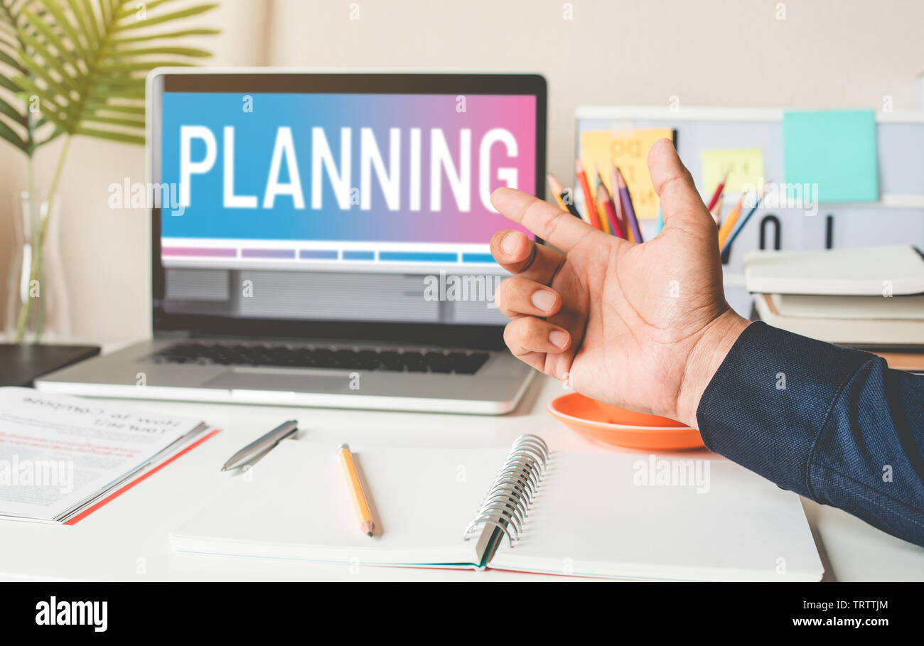 Young man showing planning text in presentation on computer laptop ...