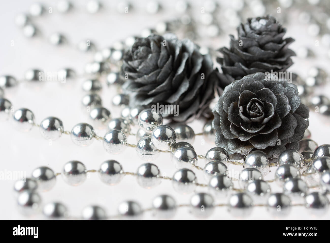 Close-up of three silver cones and bead chain on white background Stock ...