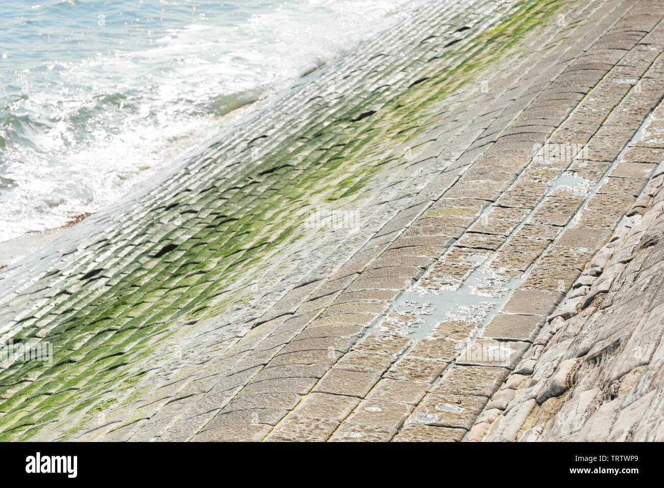 stone harbour wall construction and ocean waves Stock Photo - Alamy