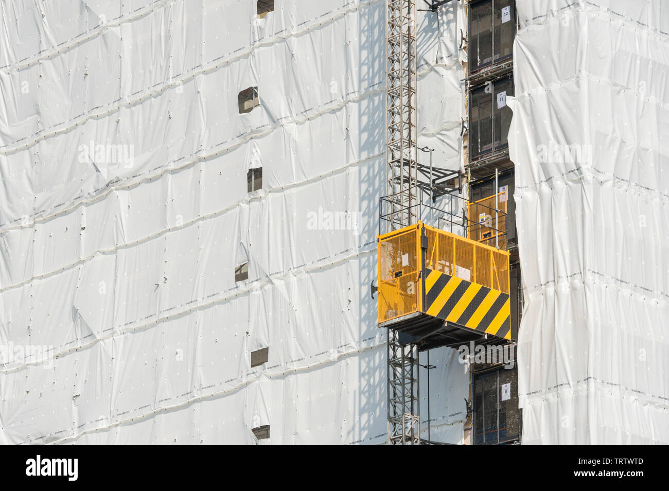 small elevator on the exterior of a tower block building construction ...