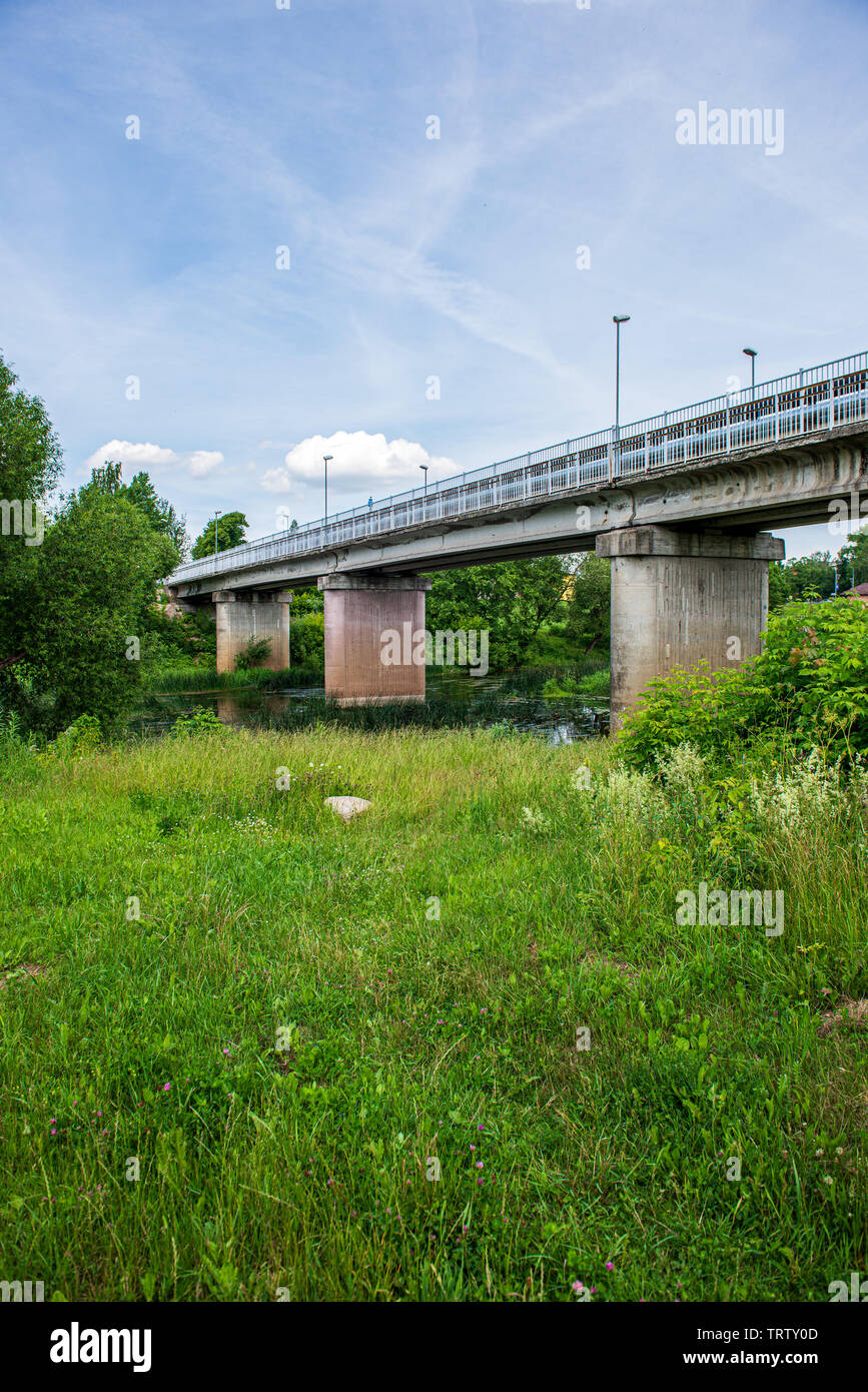 concrete brick bridge over the river with high clear water stream Stock ...