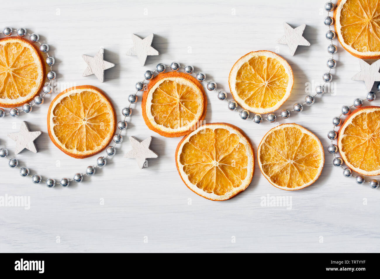 Christmas composition with dried oranges, white stars and silver bead ...
