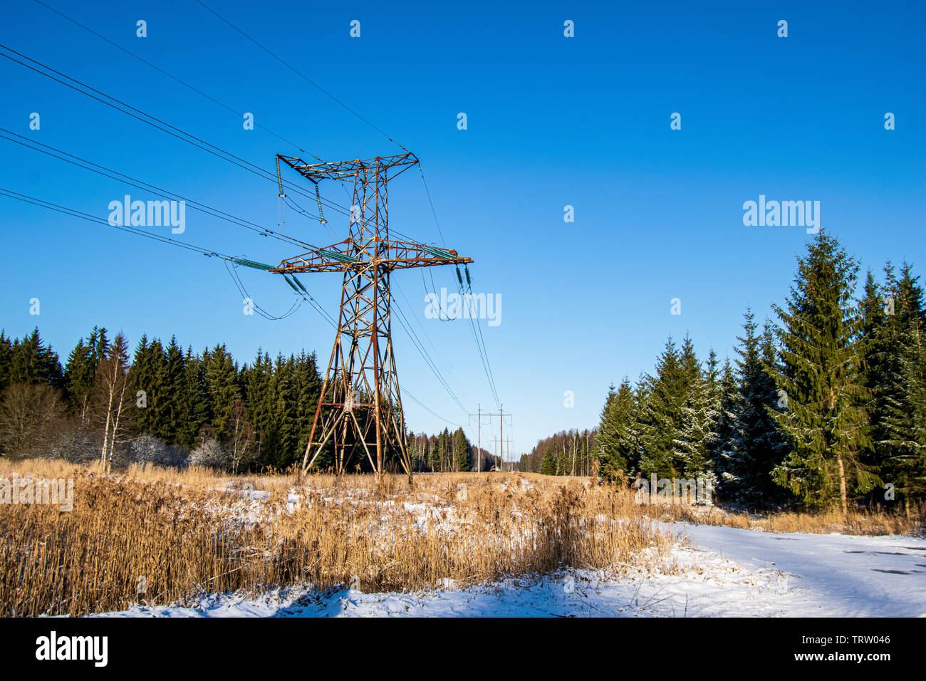 electricity power line poles construction in middle of fields in ...