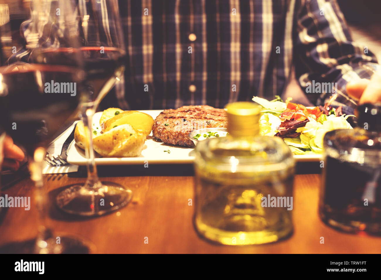 view of table with meet burger and salad for dinner in a restaurant ...