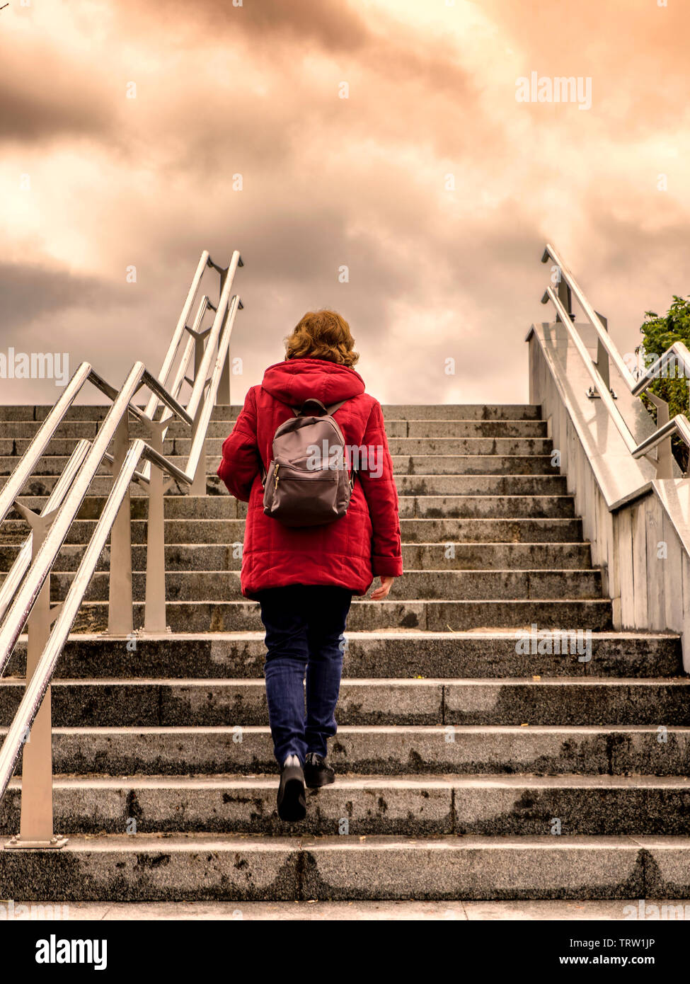 Woman walking up stairs success hi-res stock photography and images - Alamy