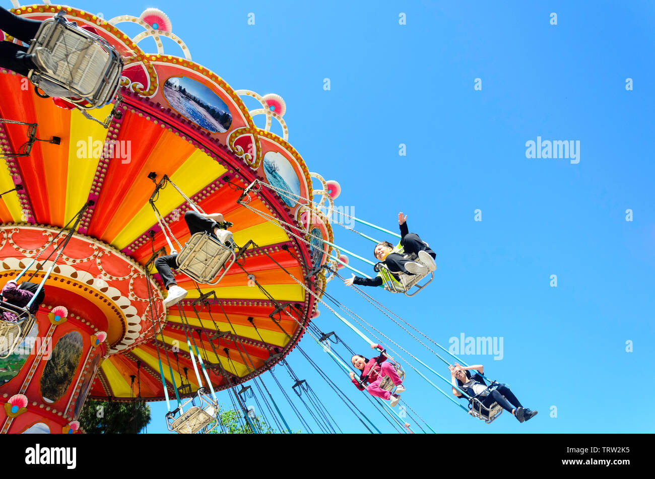 Children enjoy riding a Chairoplane Stock Photo - Alamy