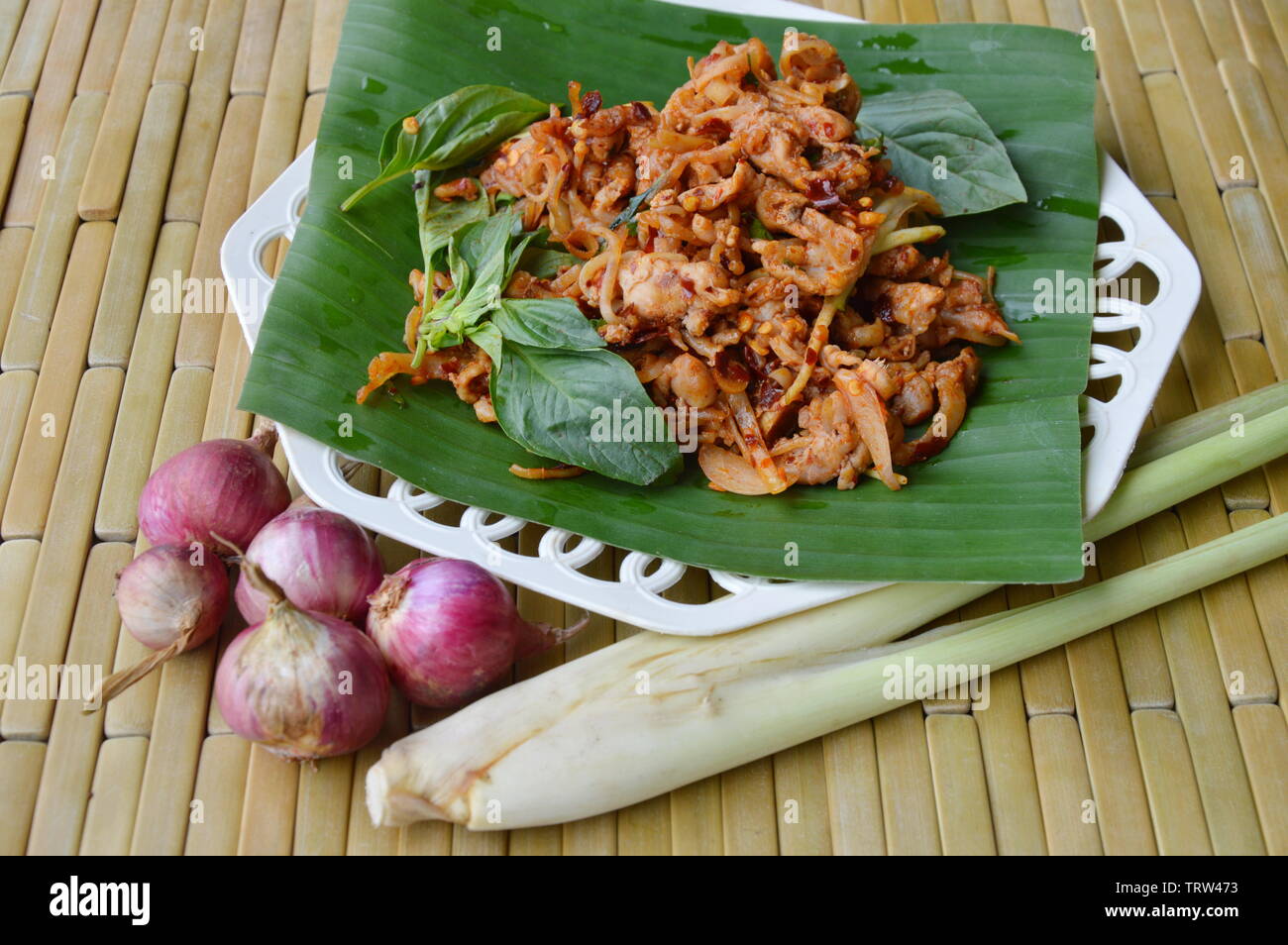 spicy chicken ligament salad on banana leaf Stock Photo - Alamy