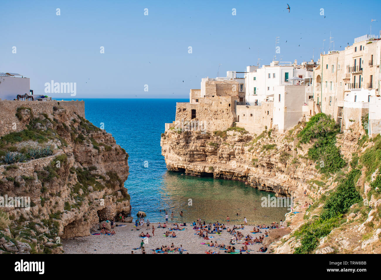Panoramic city skyline with white houses and beach, town on the rocks ...