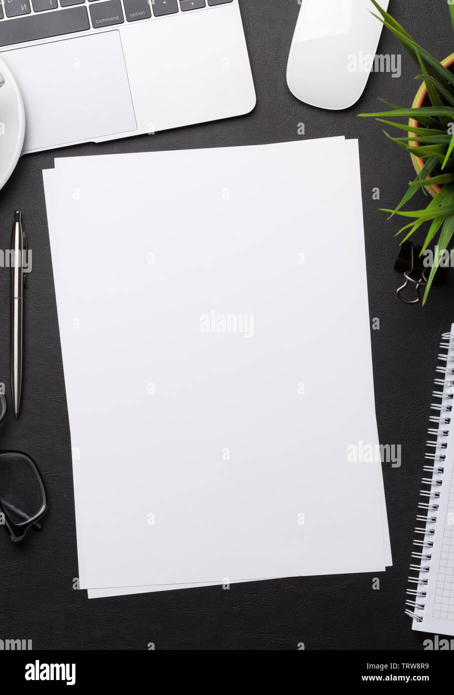 Office workplace table with blank paper page, coffee cup, supplies and ...