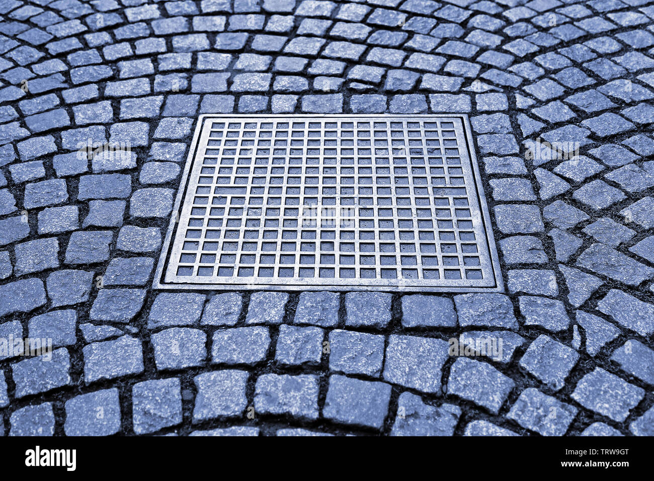 Paving stones background with metal plate Stock Photo - Alamy