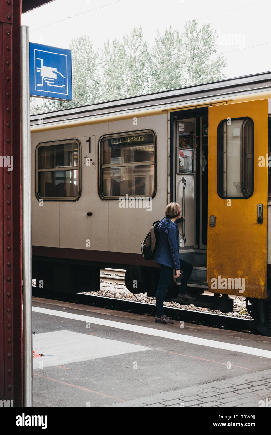 Dommeldange, Luxembourg - May 18, 2019: Woman boarding a train at ...