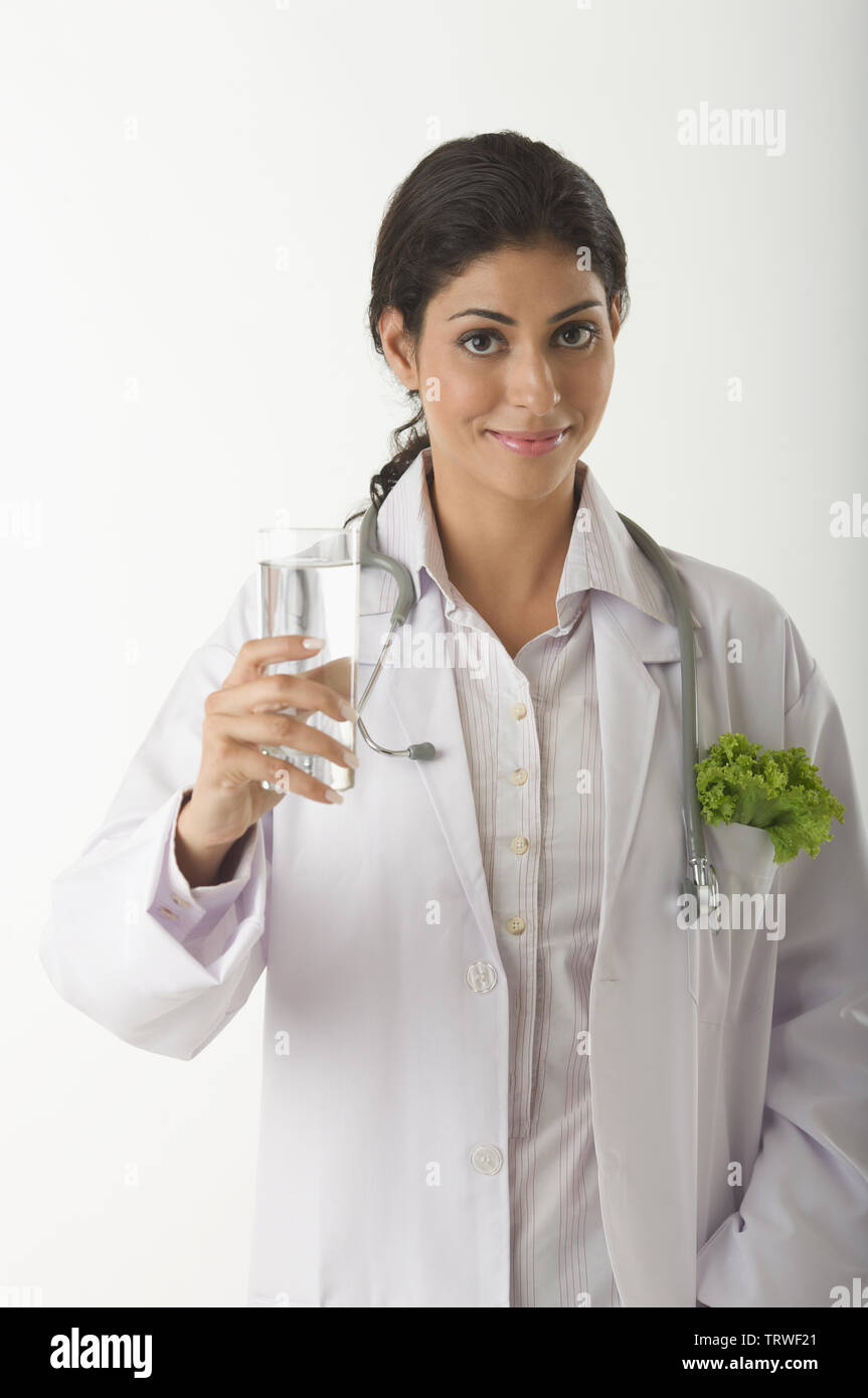 Female doctor holding a glass of water Stock Photo - Alamy