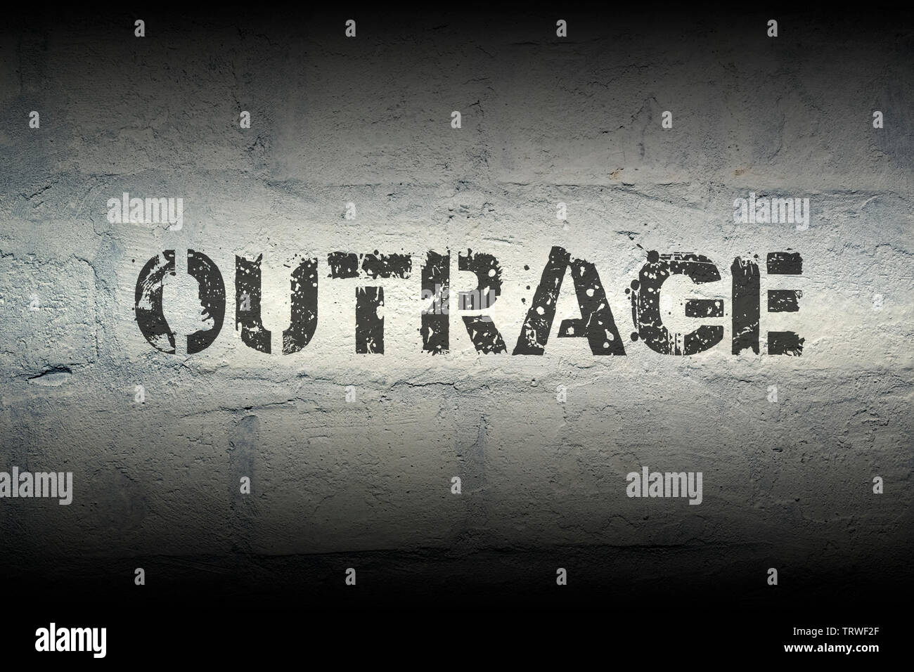 outrage stencil print on the grunge white brick wall; specially ...