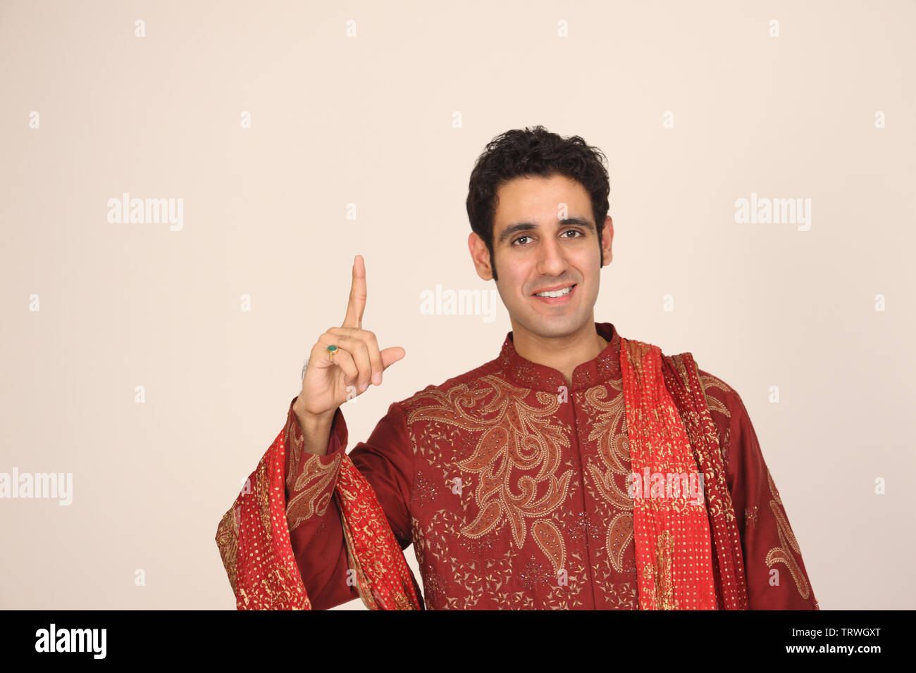 Man in traditionally Indian attire and holding index finger up Stock ...